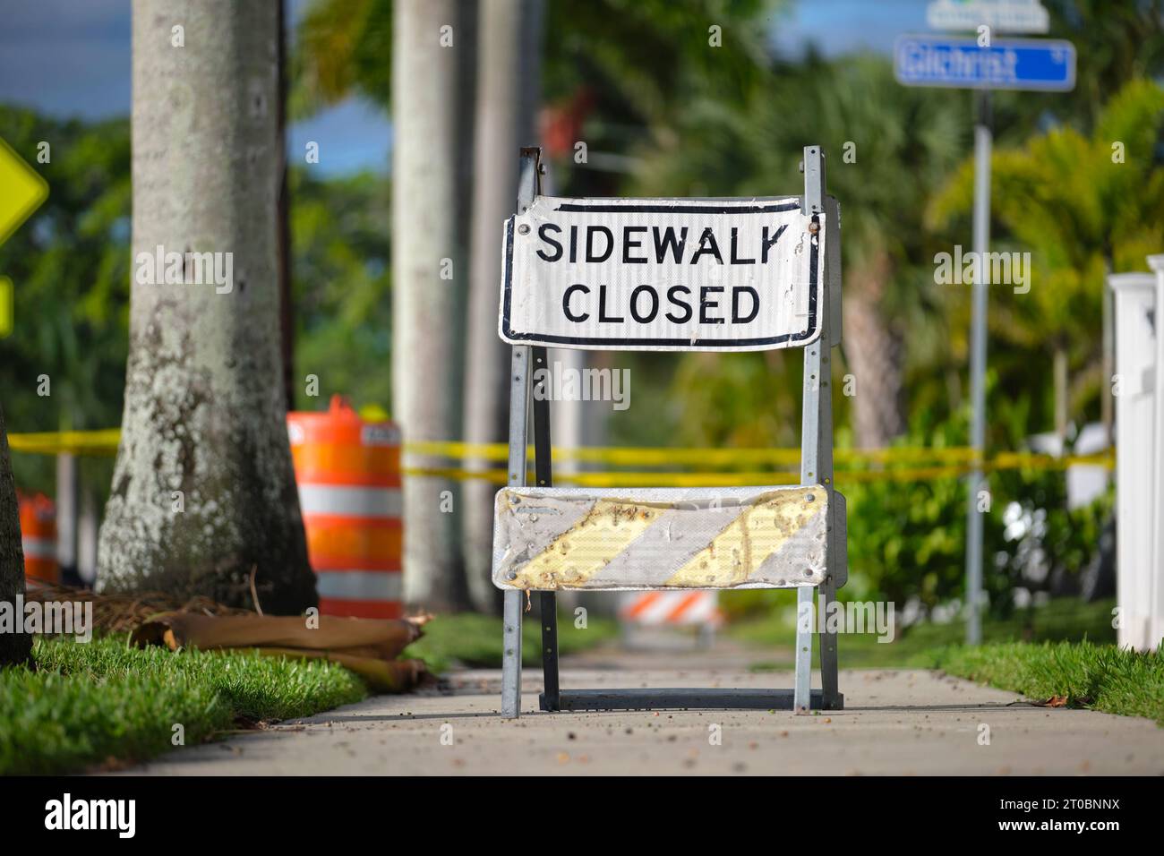 Warning sign that sidewalk is closed at street construction site ...