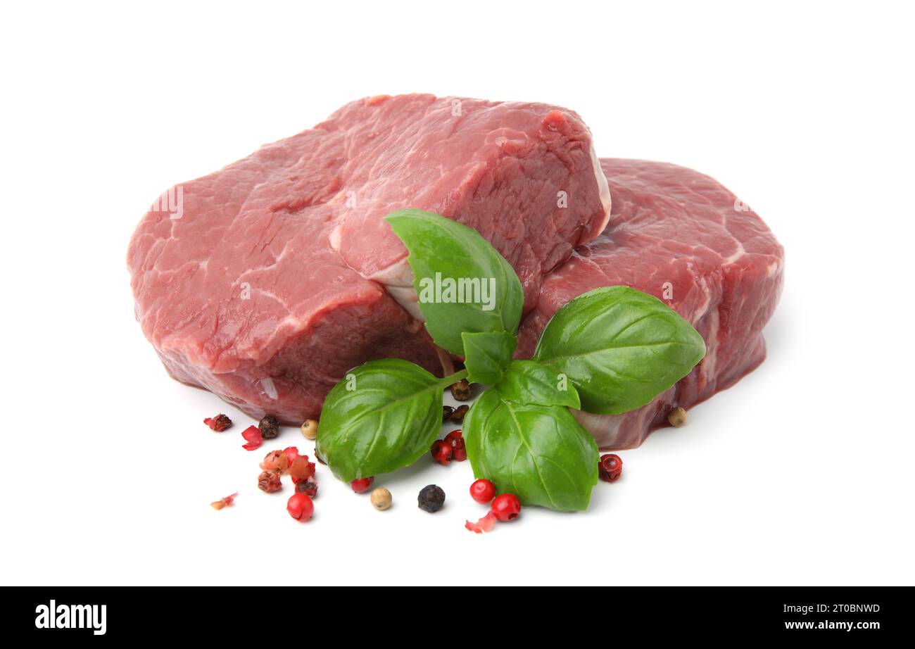 Fresh beef meat with basil leaves and spices isolated on white Stock ...