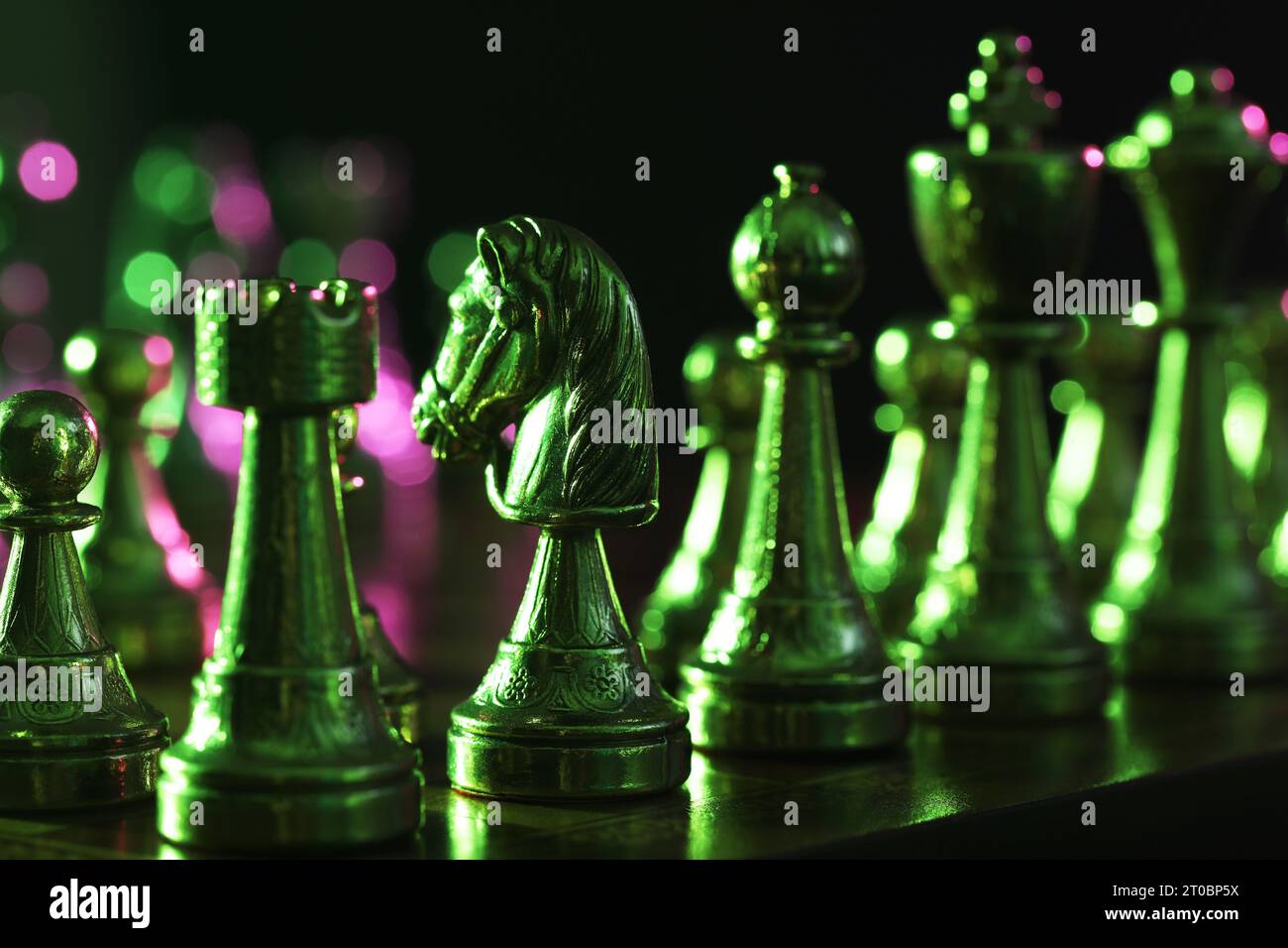 Chess pieces on checkerboard in color light, closeup Stock Photo - Alamy