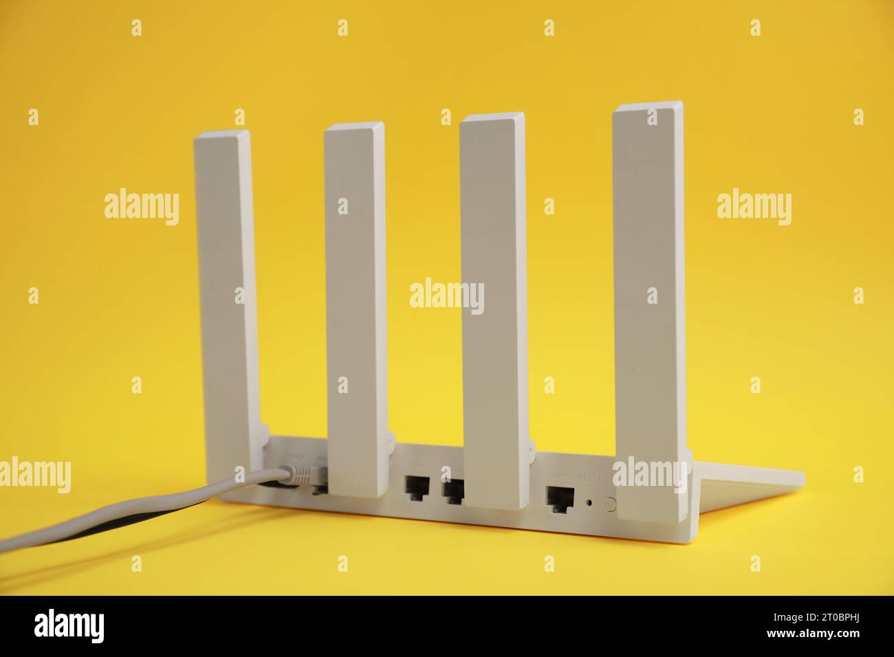 One modern Wi-Fi router on yellow background Stock Photo - Alamy
