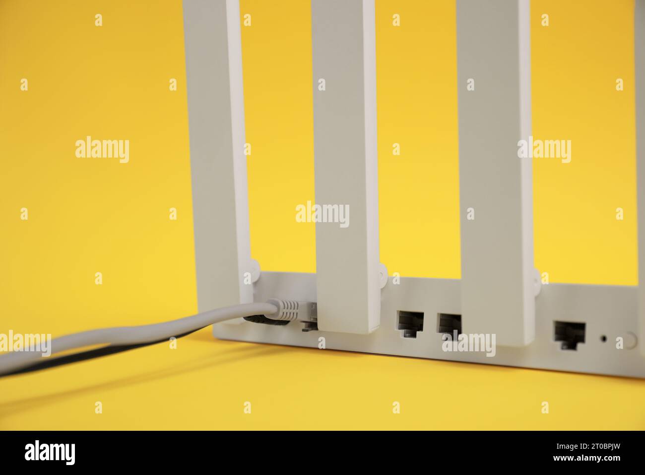 Modern Wi-Fi router on yellow background, closeup Stock Photo - Alamy
