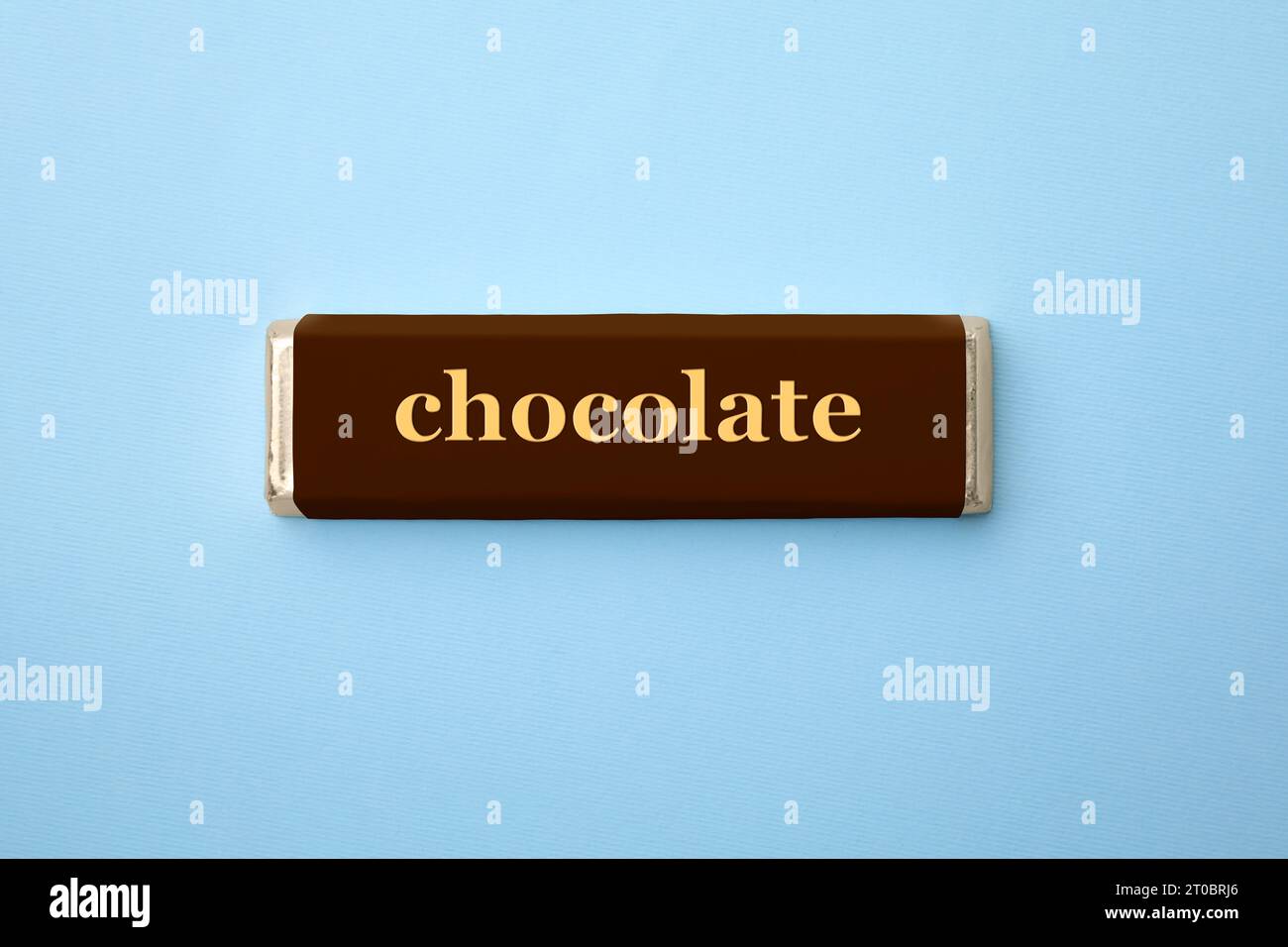 One chocolate bar in packaging on light blue background, top view Stock ...