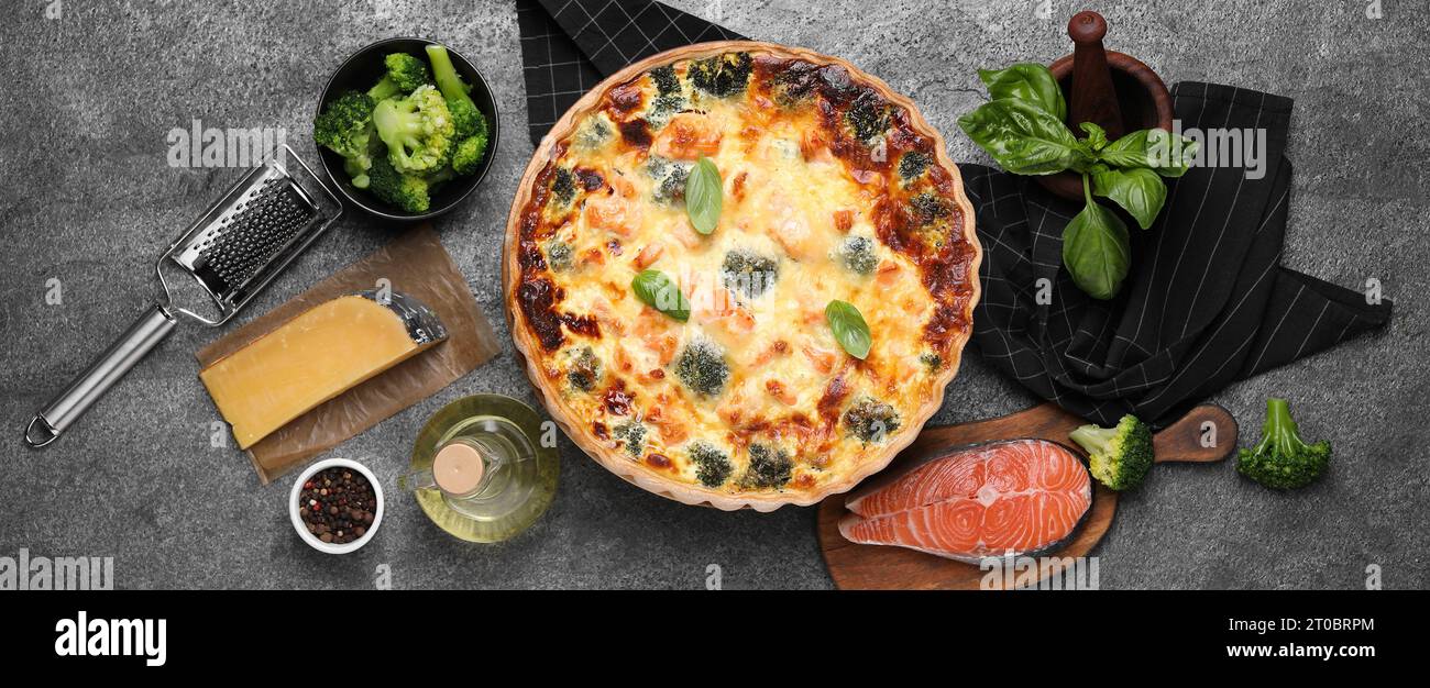 Delicious homemade quiche and ingredients on gray table, flat lay ...
