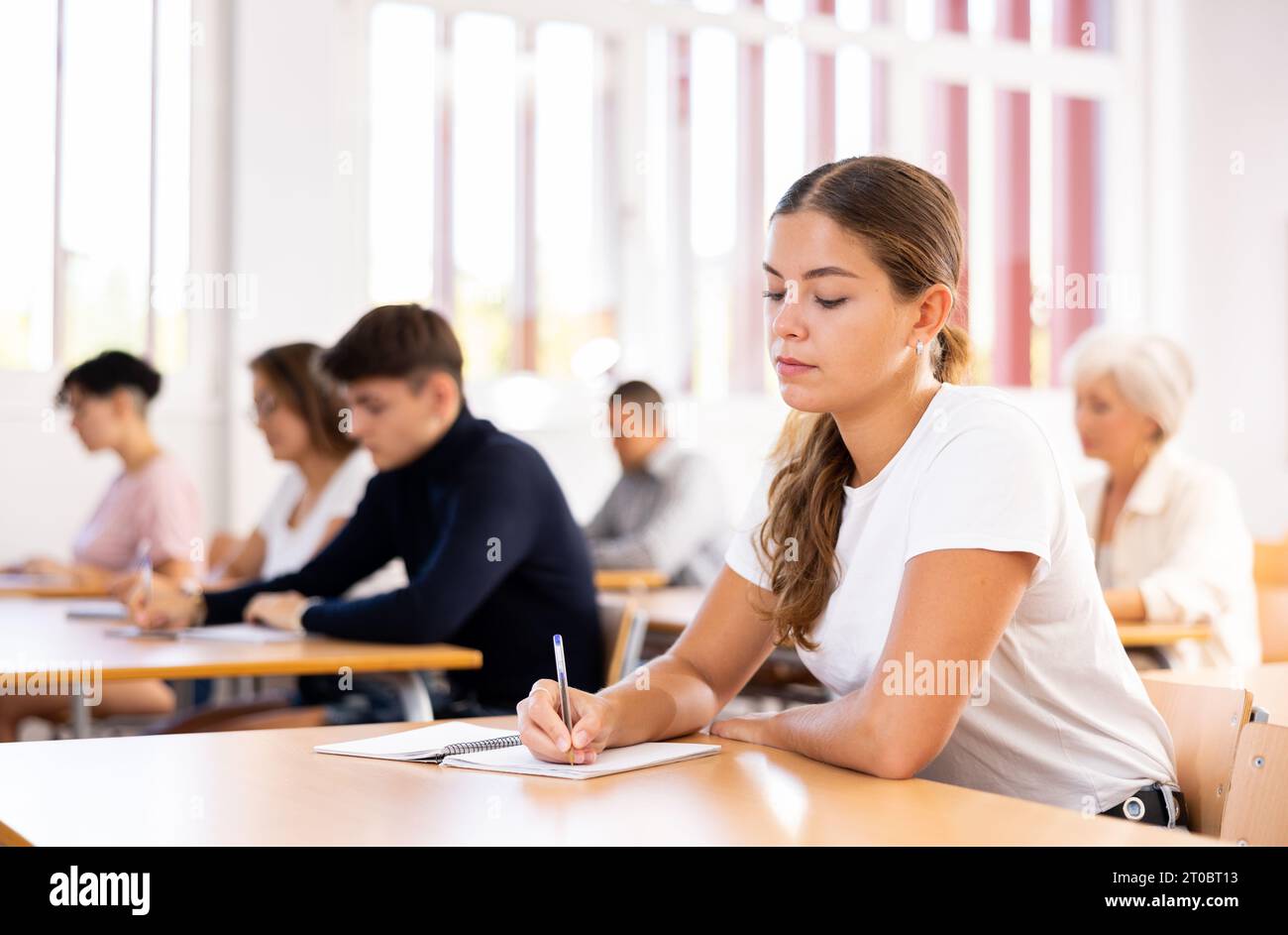 Girl attending lecture in college Stock Photo - Alamy