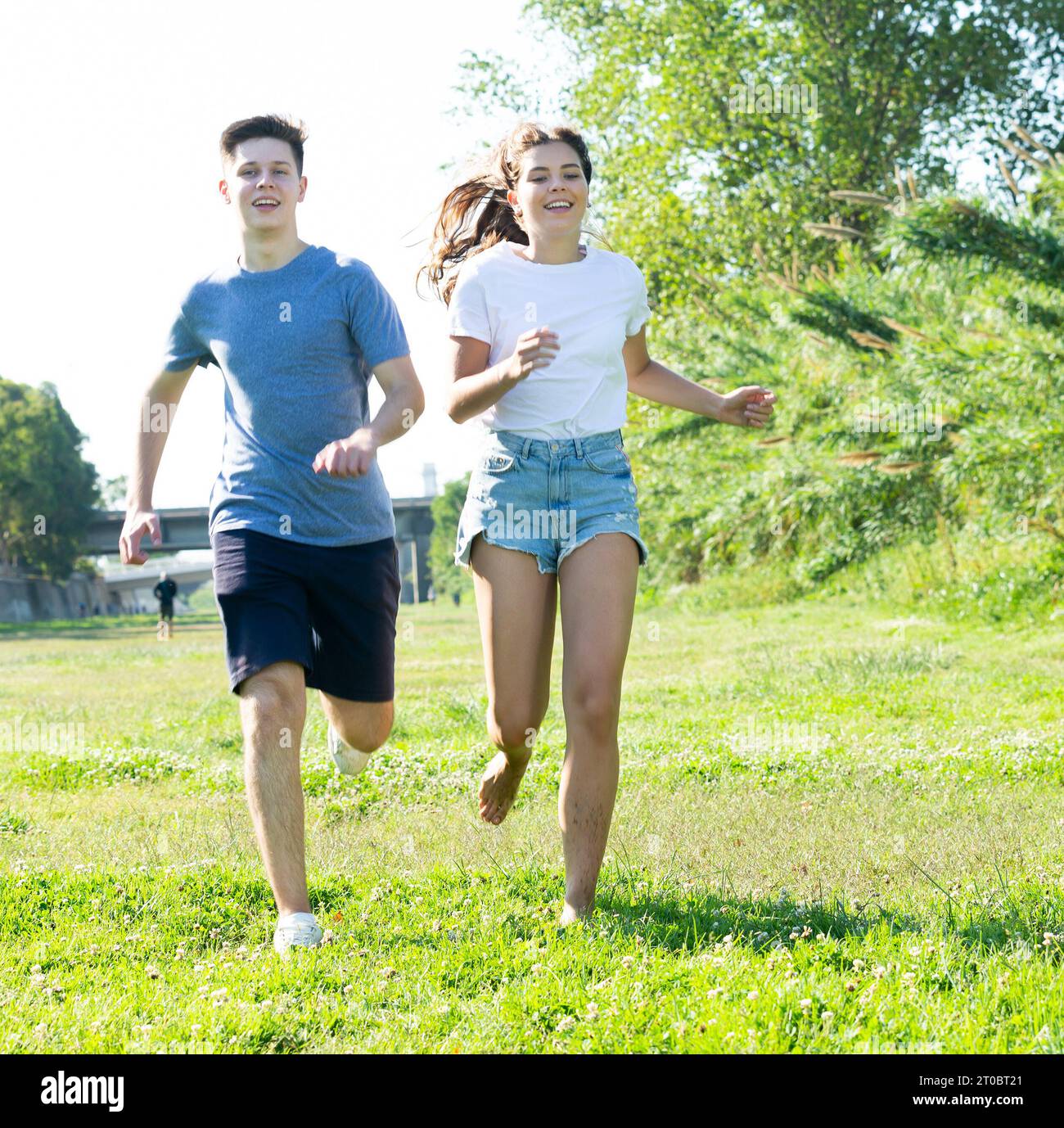 Two teenagers running boy girl hi-res stock photography and images - Alamy