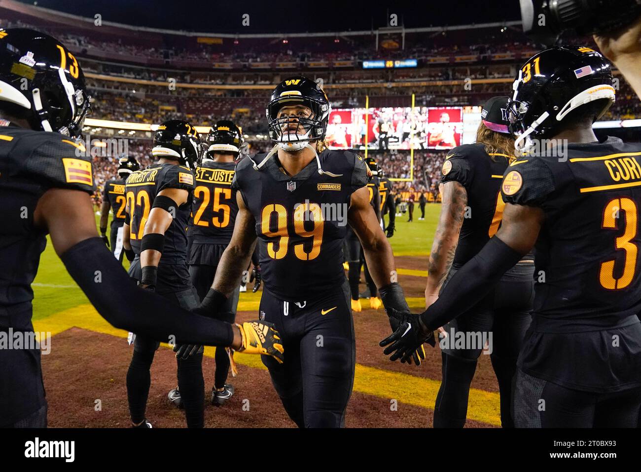 Washington Commanders defensive end Chase Young (99) greeting teammates ...