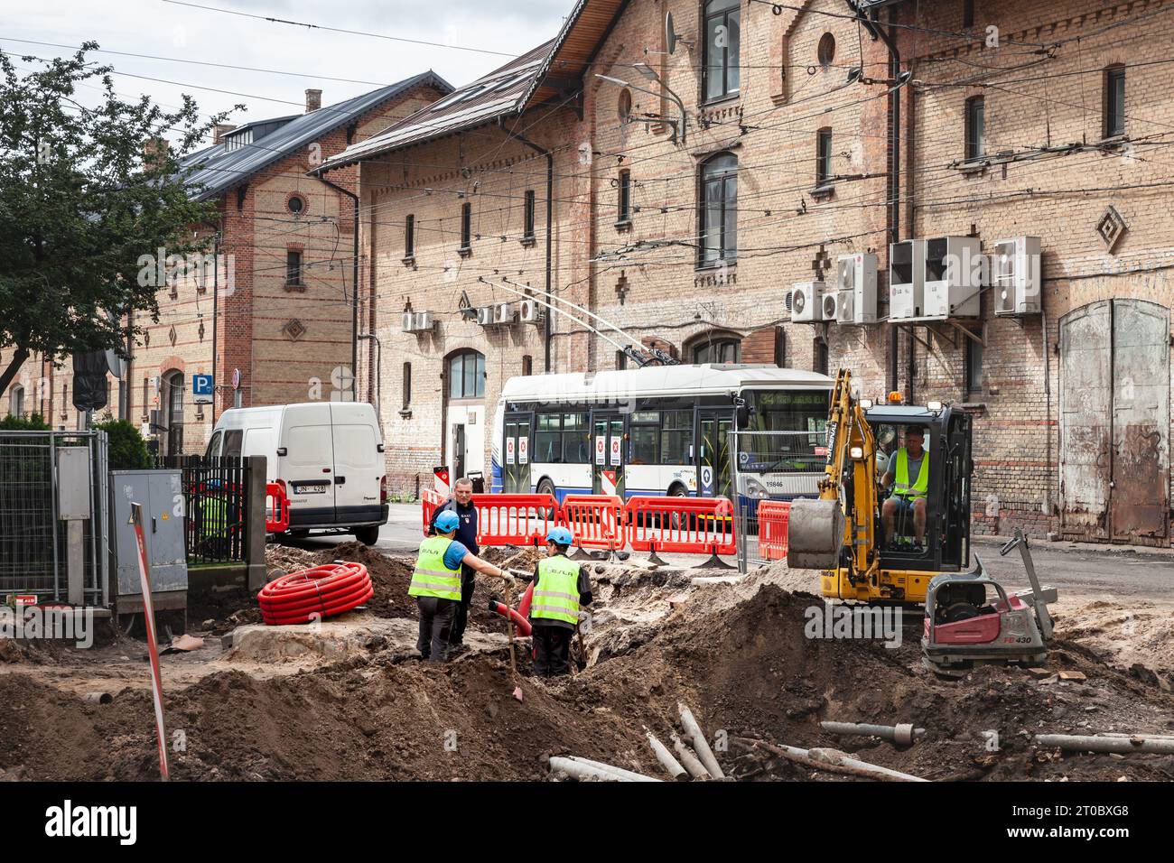 Picture of men working, digging trenches in the center of Riga during a ...