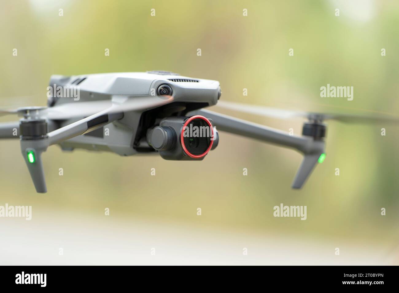 Drone aircraft with blurred fast rotating propellers and video camera ...