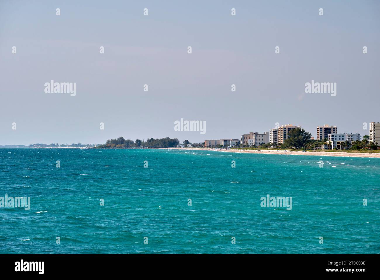 Resort Beach With White Sand Blue Water Tall Hotel Buildings Happy People Sunbathing And