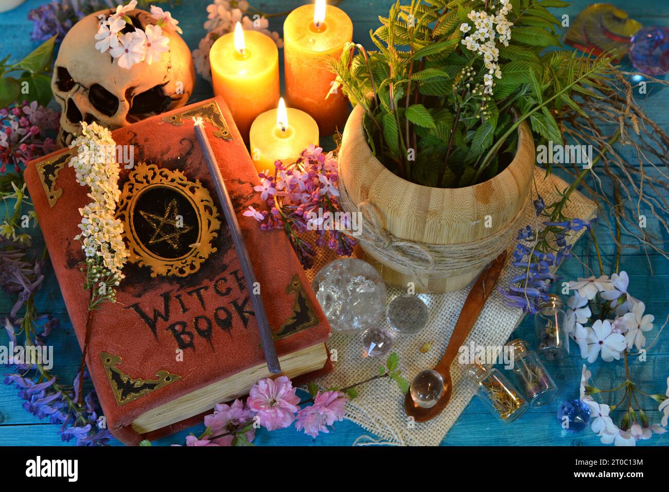 Old witch book with mortar and candles on ritualaltar table. Occult ...