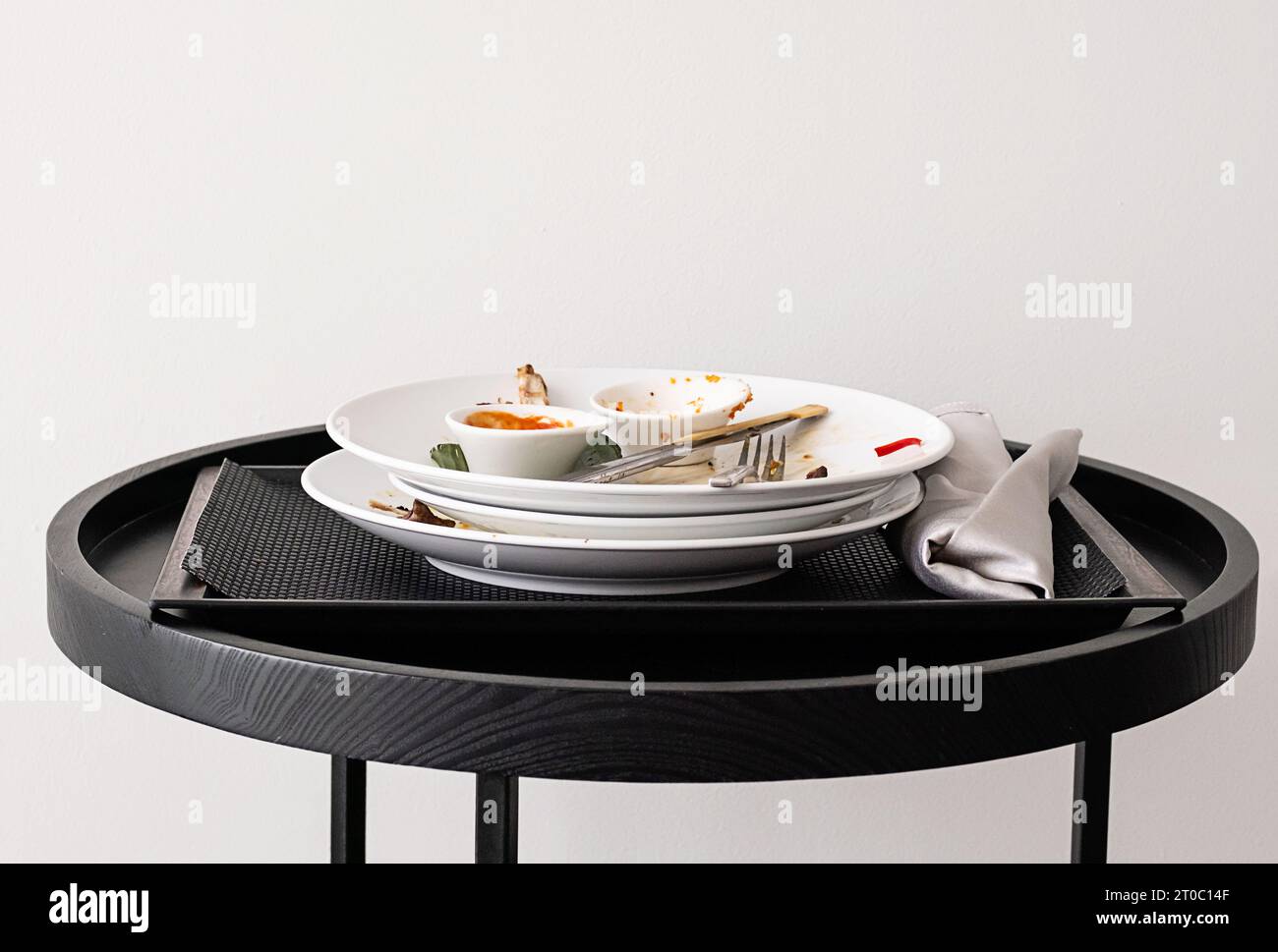 Stack of messy plates left on table after diner Stock Photo - Alamy