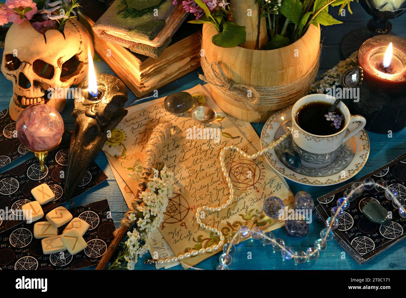 Runes, manuscript of spells and magic wand on witch ritual altar ...