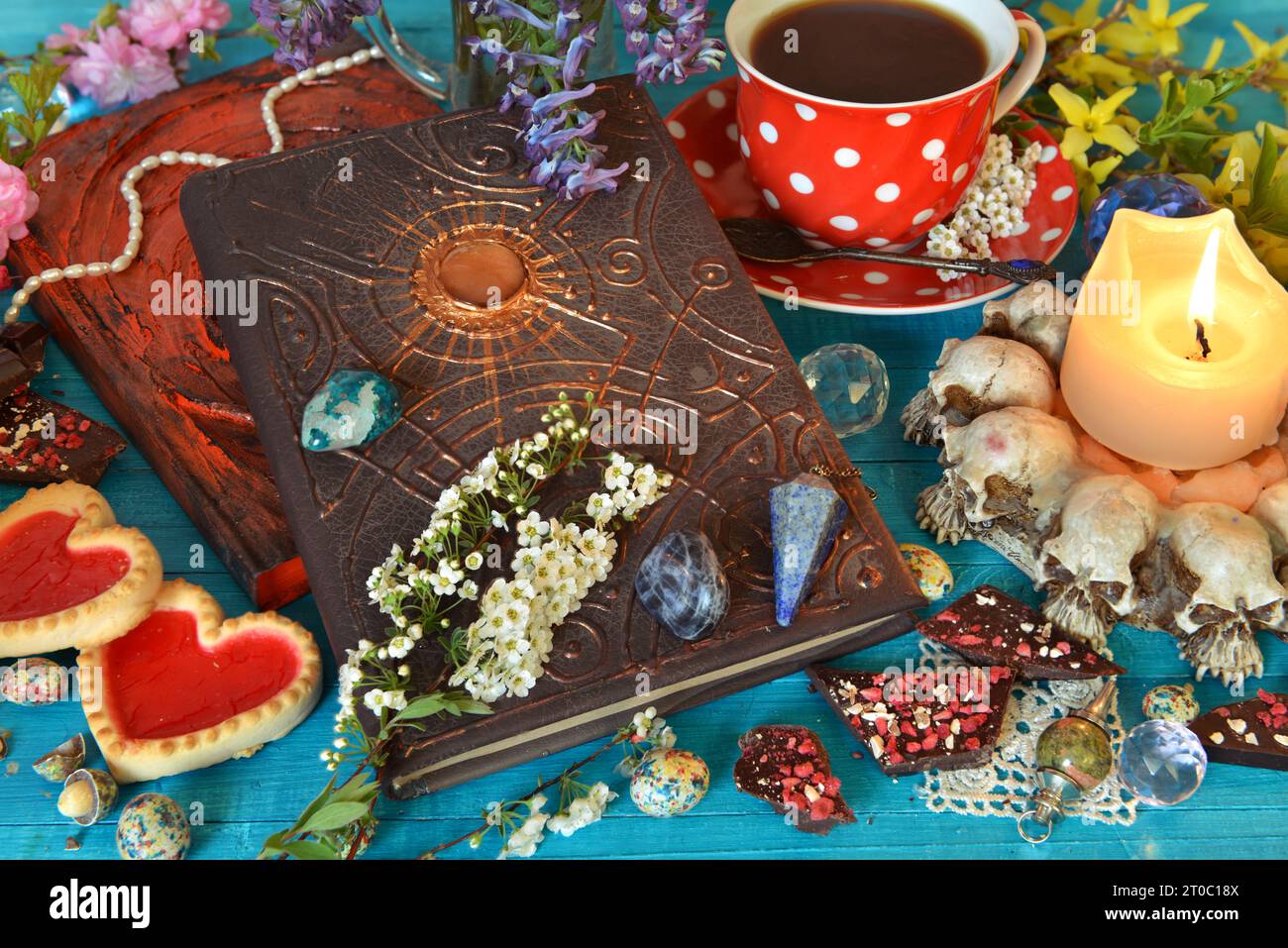 Candle and magic book on witch altar table. Occult, esoteric and ...