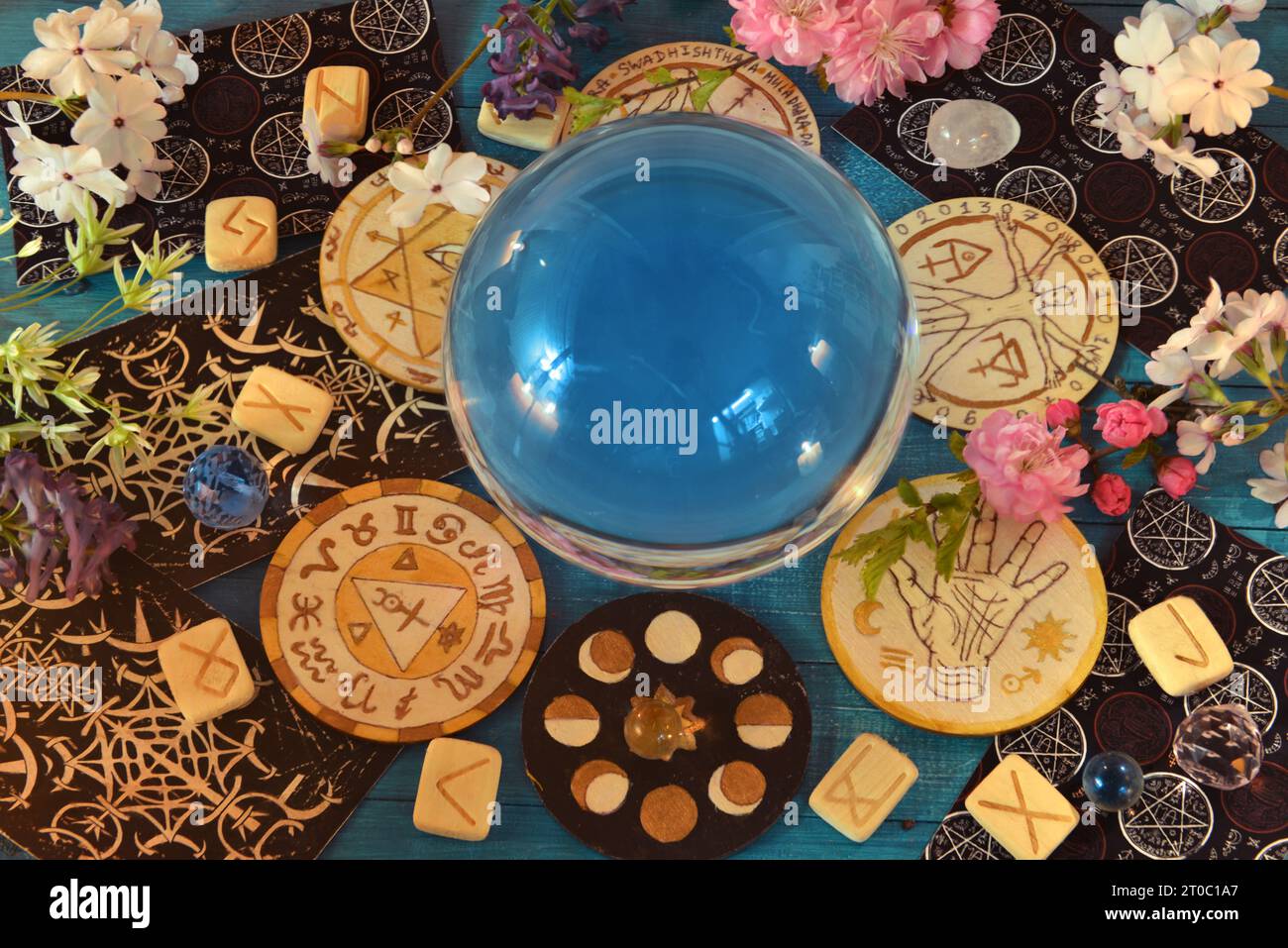 Magic ball and runes on witch ritual table. Occult, esoteric and ...