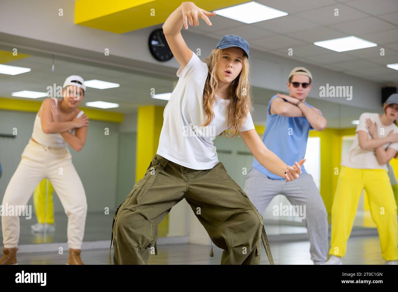 Expressive cool young dancers rehearsing their new dance during ...