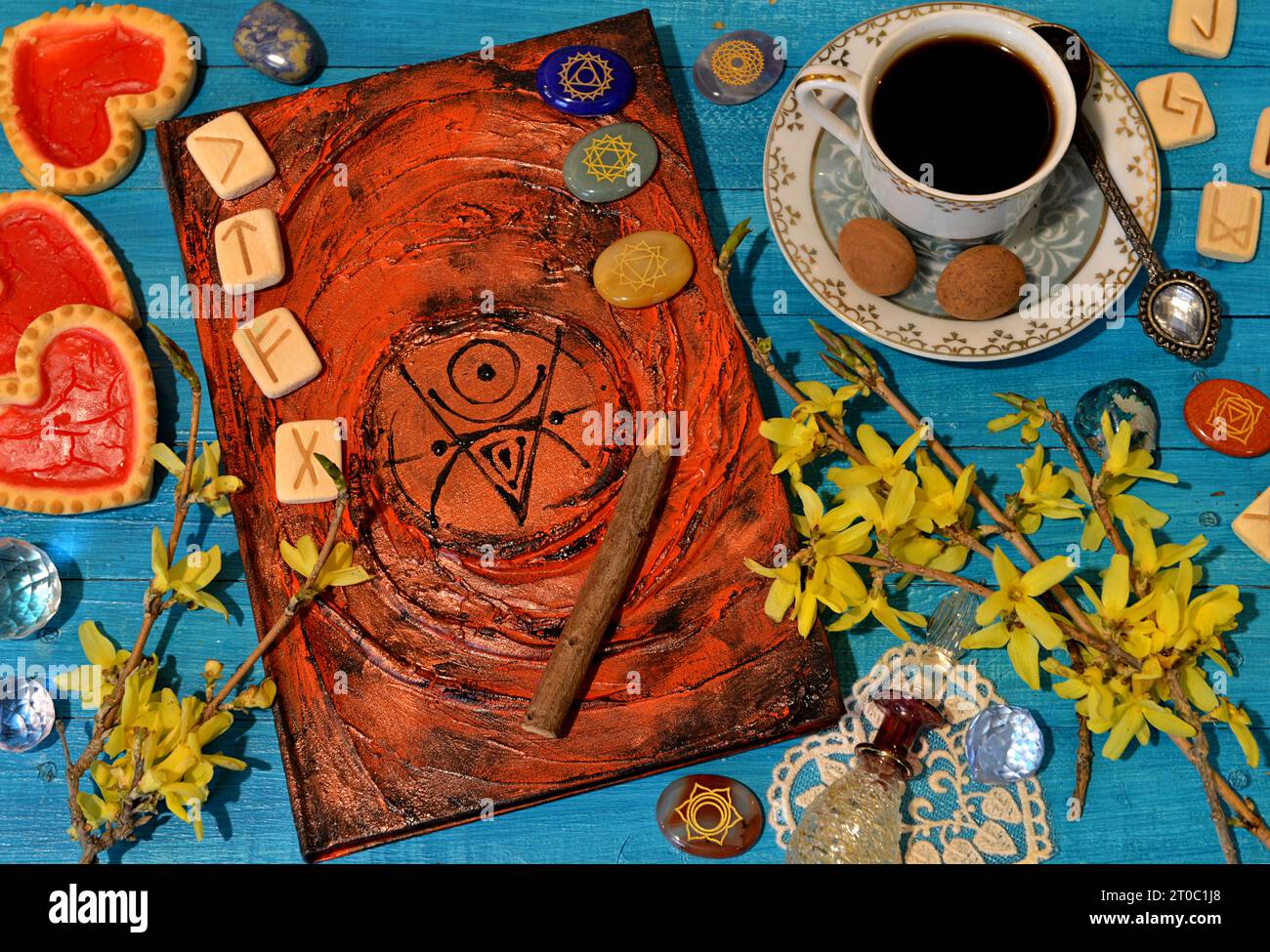 Old magic book with spells, runes, crystals and cup on witch altar ...