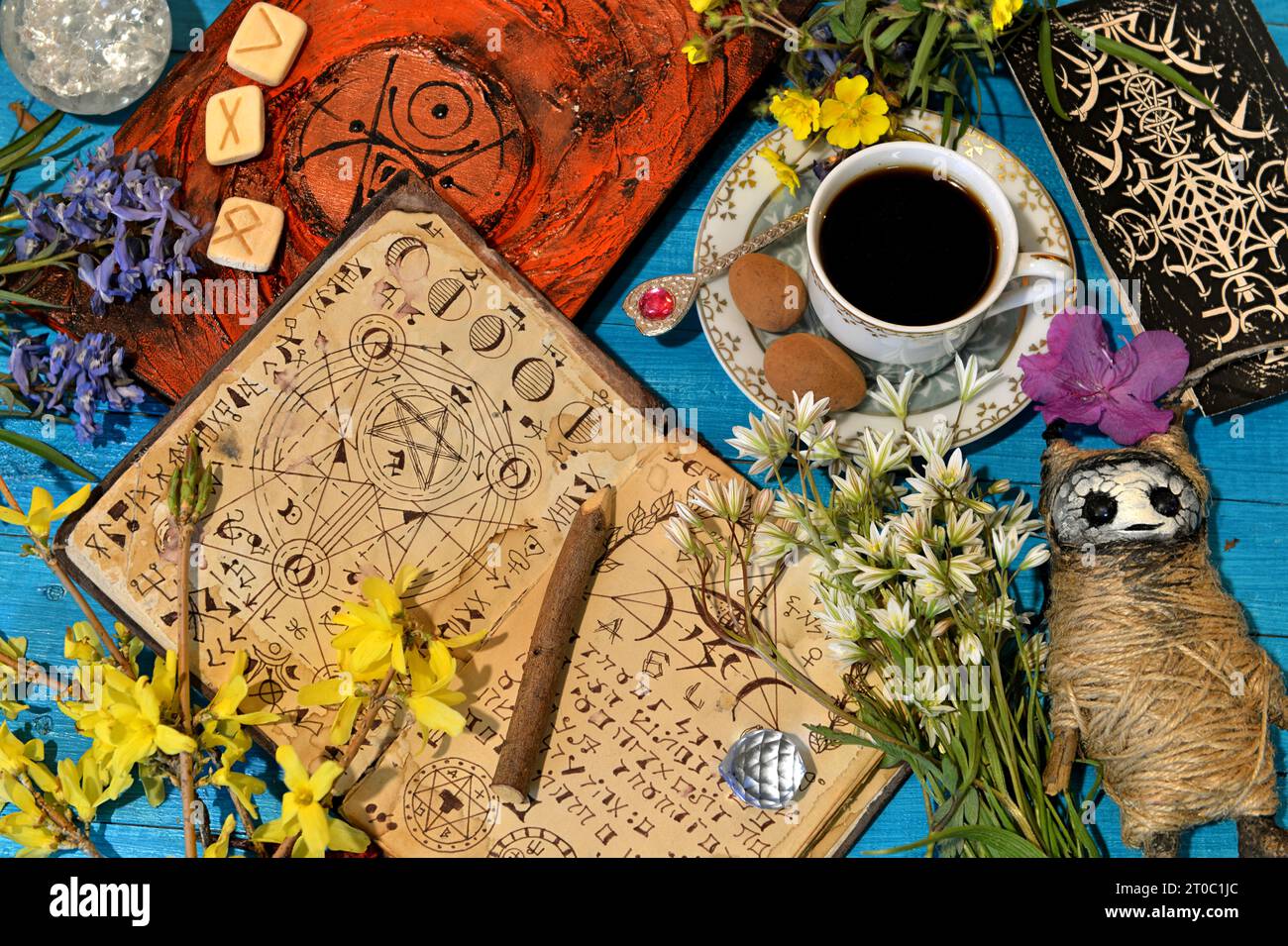 Old book with spells, voodoo doll and tarot cards on witch table ...