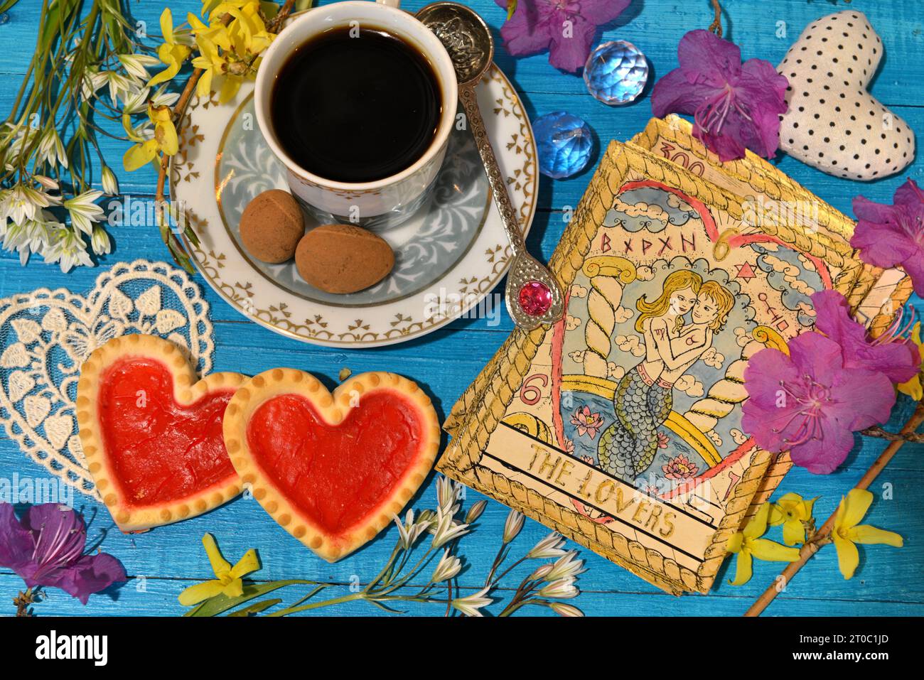 Tarot cards with love symbols, old cup and cookies on witch ritual ...