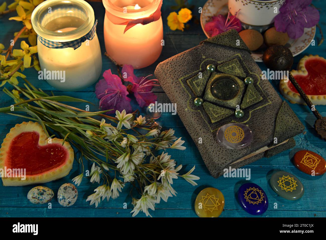 Book of spells, candles and chakras on witch ritual table. Occult ...