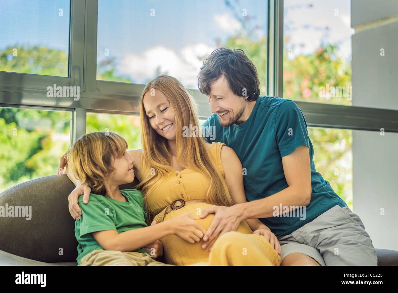 Expectant parents, mom, dad, and their eldest son share a heartwarming ...