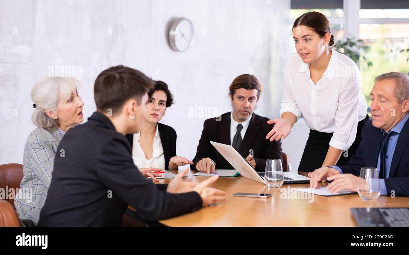 Female director gives instructions to managers in deliberation room ...