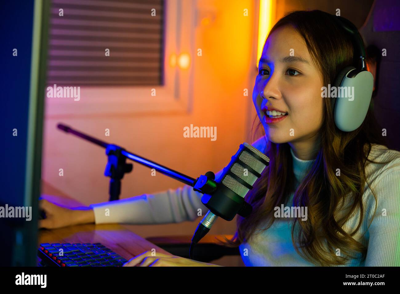 Asian young gamer woman playing video games online on computer she live ...