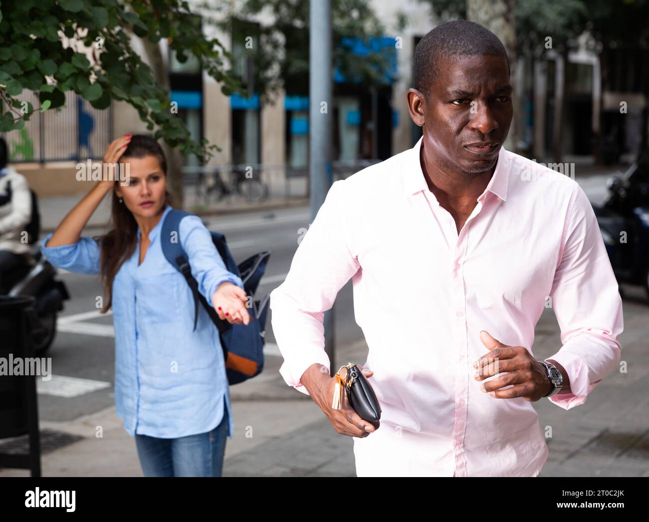 Guy with stolen wallet running away Stock Photo - Alamy