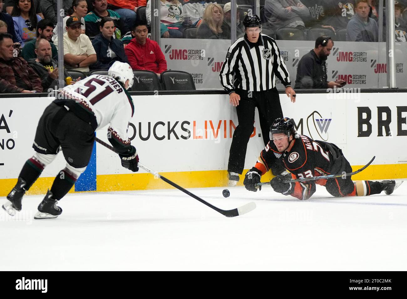 Arizona Coyotes defenseman Troy Stecher, left, goes after the puck ...