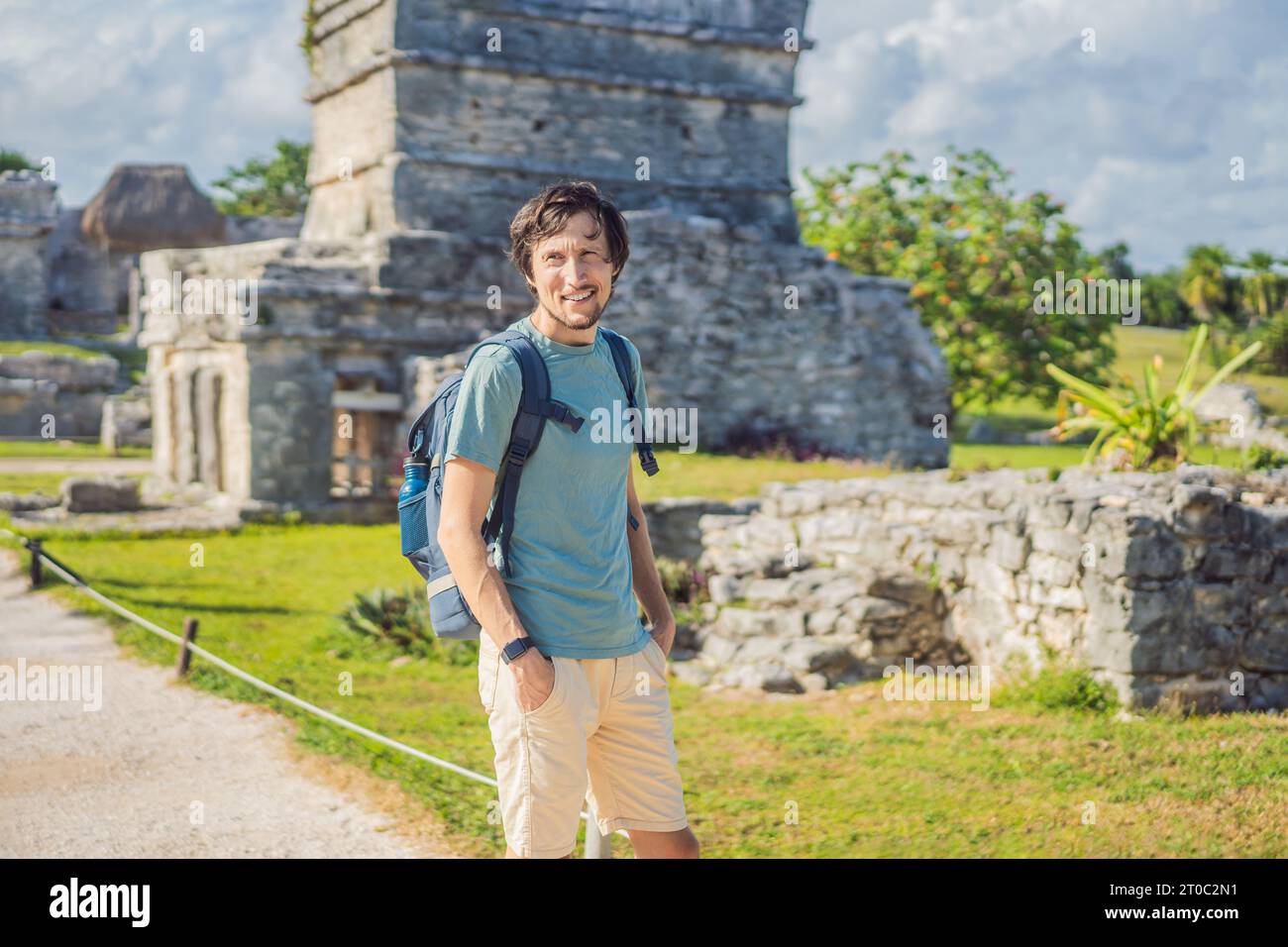 Male tourist enjoying the view Pre-Columbian Mayan walled city of Tulum ...