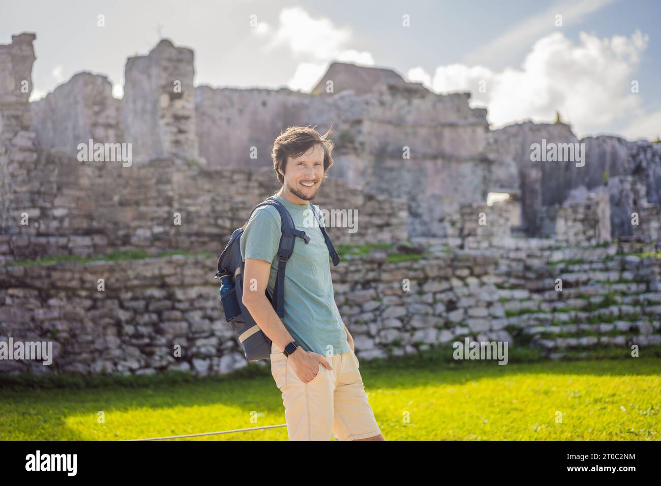 Male tourist enjoying the view Pre-Columbian Mayan walled city of Tulum ...