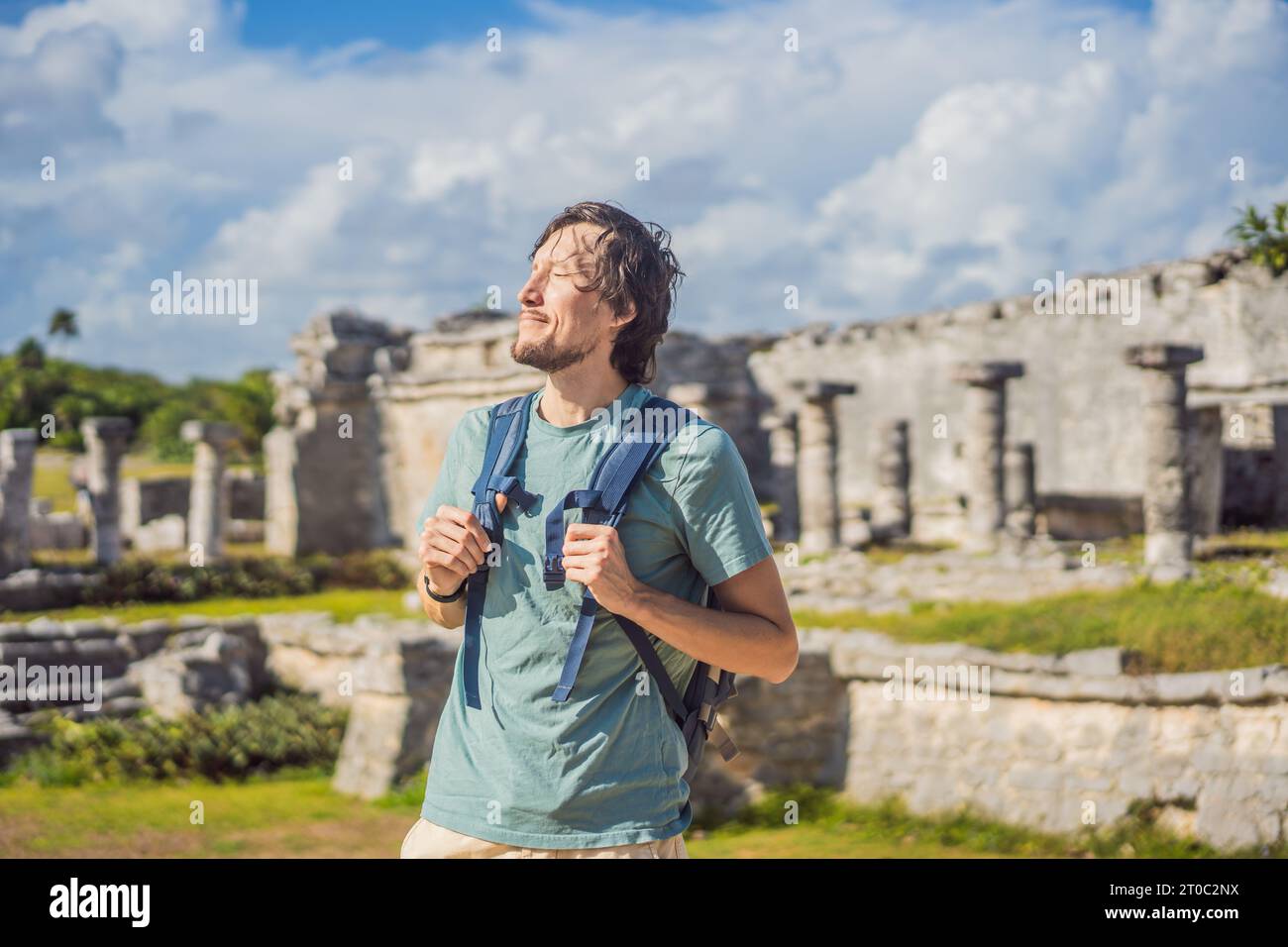 Male tourist enjoying the view Pre-Columbian Mayan walled city of Tulum ...