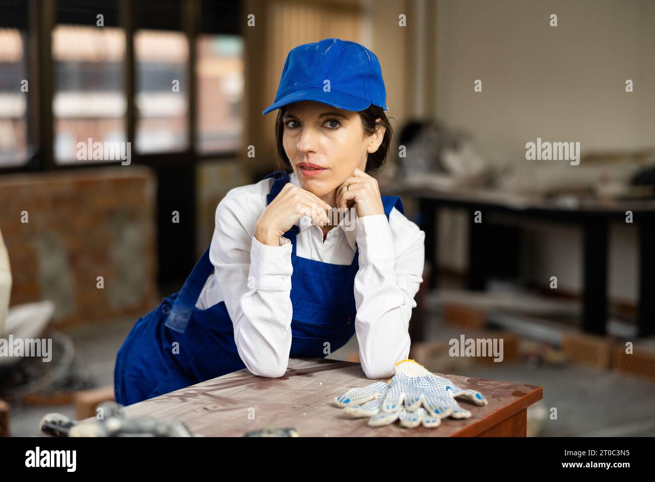 Woman construction worker posing inside house under renovation Stock ...