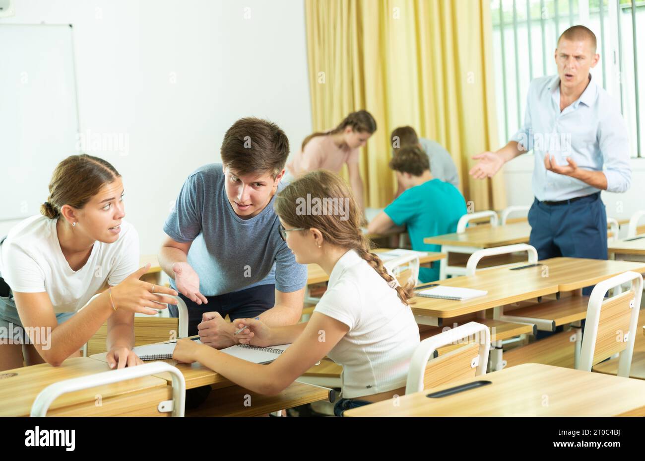 Fellow students having group work tasks during school Stock Photo - Alamy