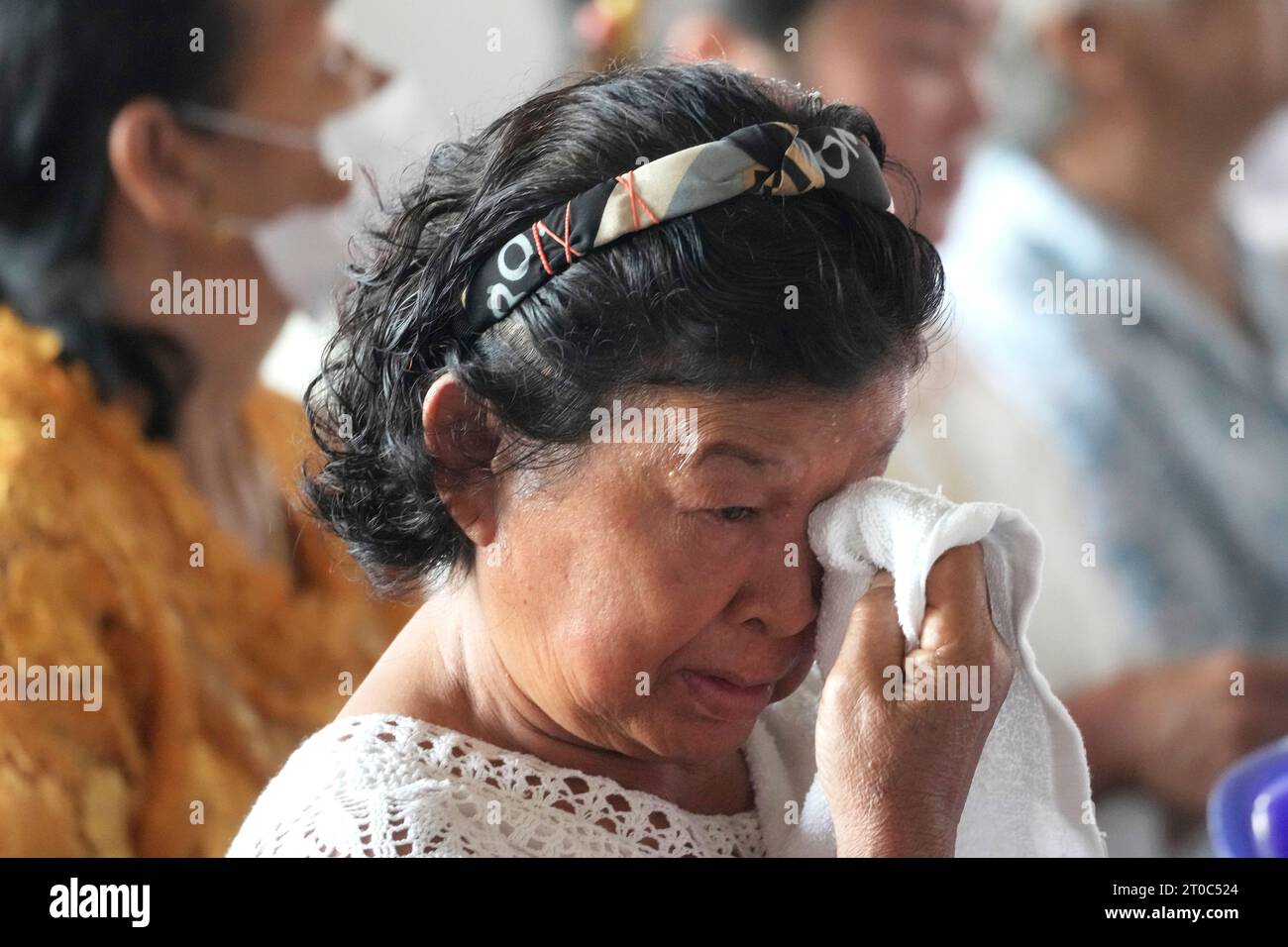 A relative of a victim cries during the Buddhist ceremony in the rural ...
