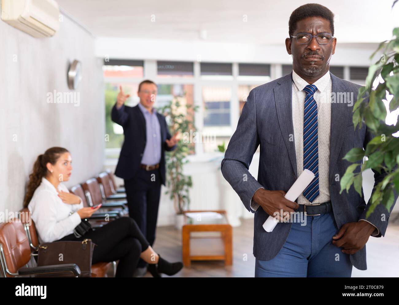 Angry hot-tempered boss shouts yells at hired employee African man in ...