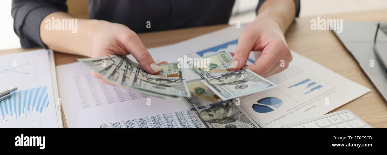 Woman counts money over table with papers and handcuffs Stock Photo - Alamy