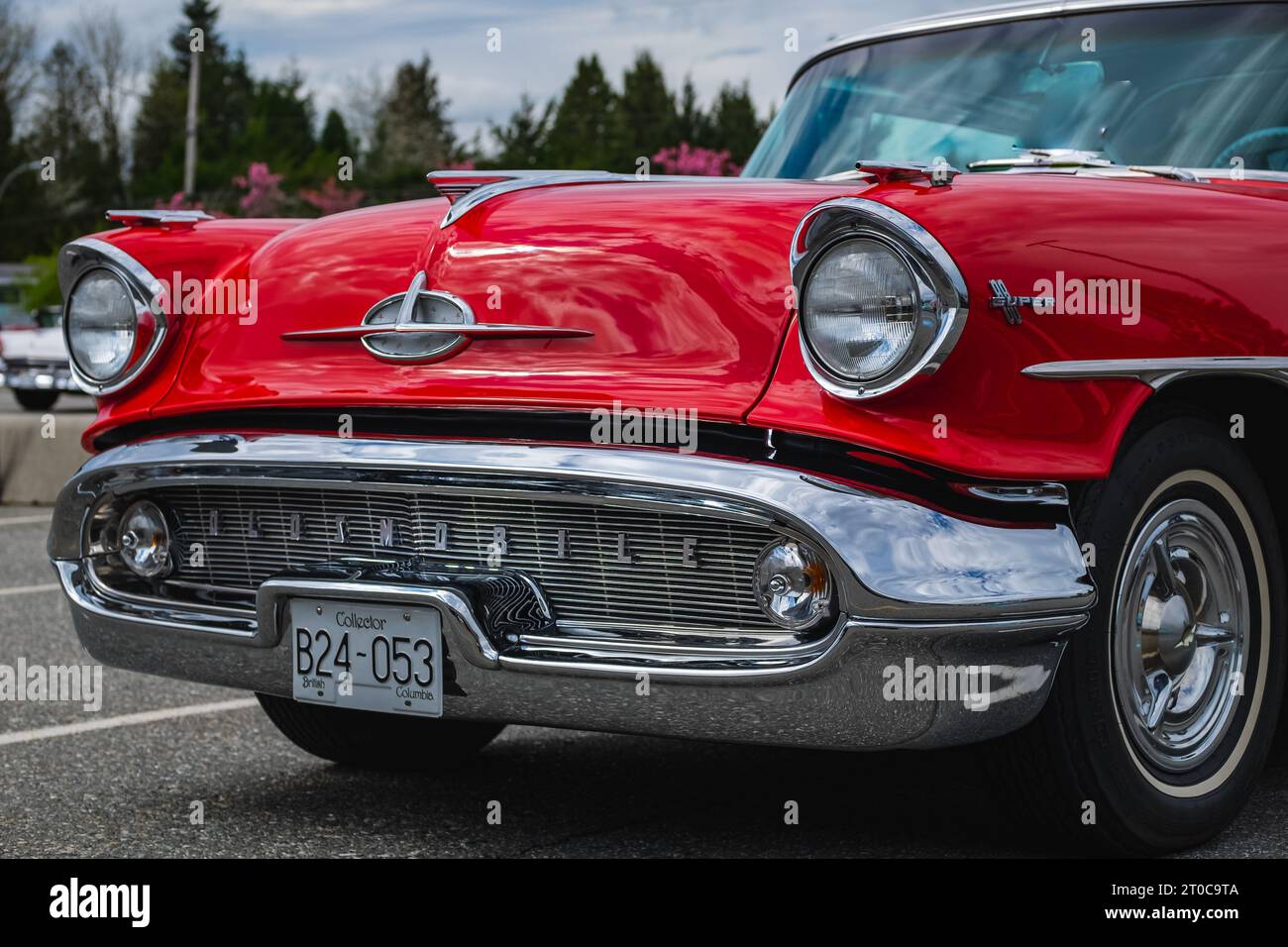 Frontal photo of a classic luxury red car. Color detail on the ...