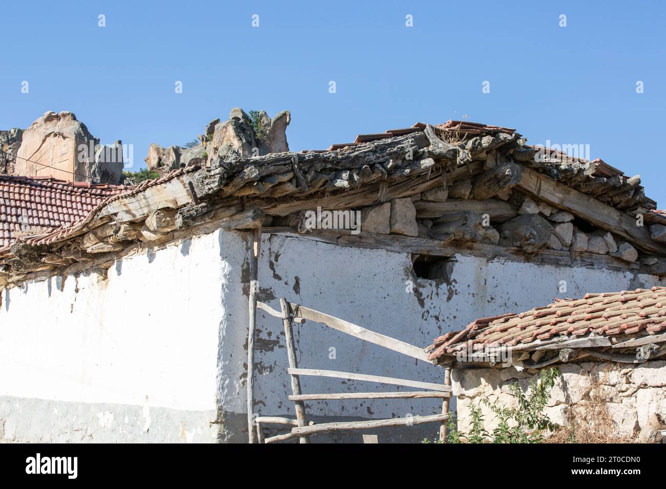 The old broken roof of a village house with white walls Stock Photo - Alamy