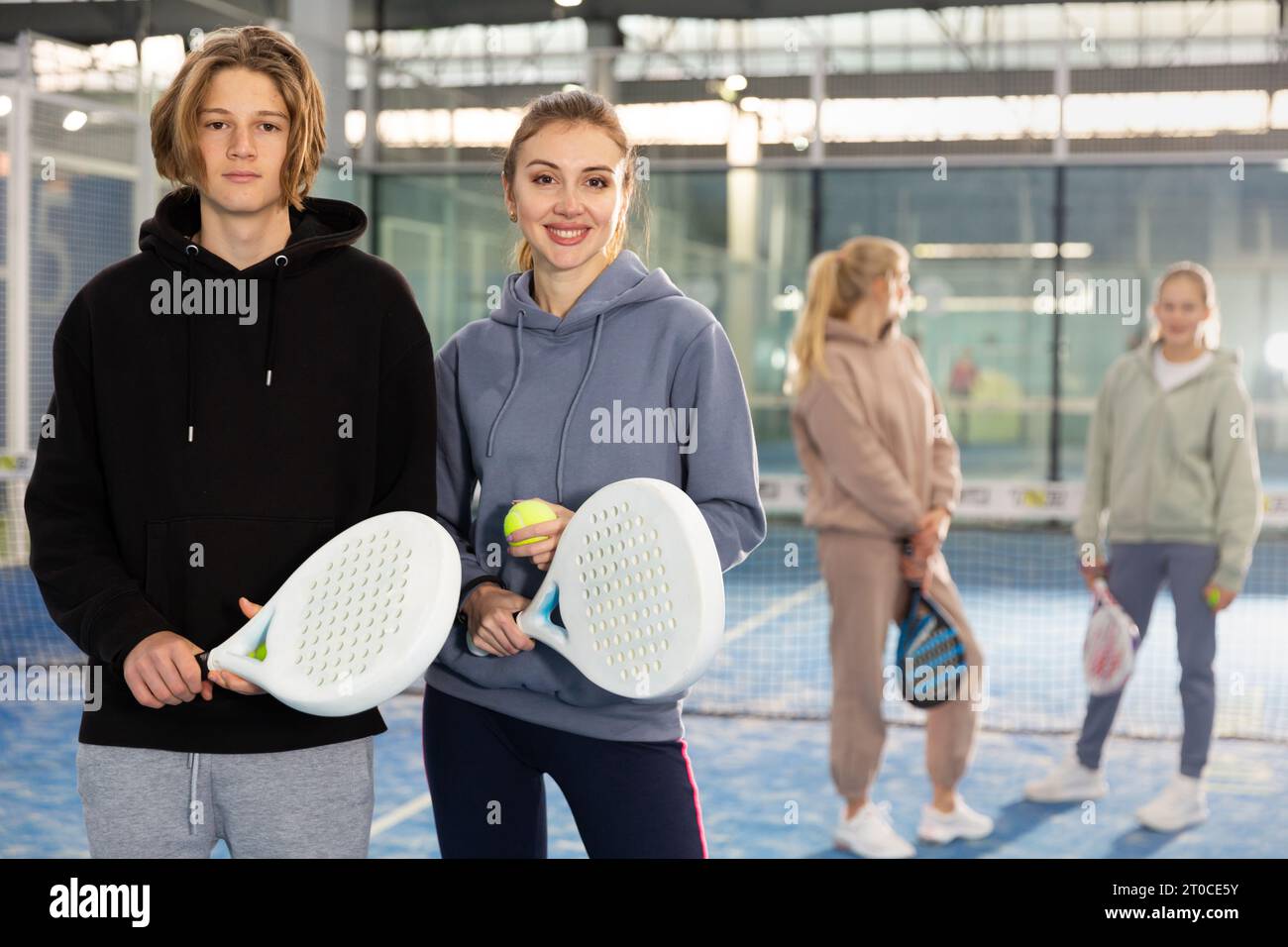 Teenage boy and young woman in padel court Stock Photo - Alamy