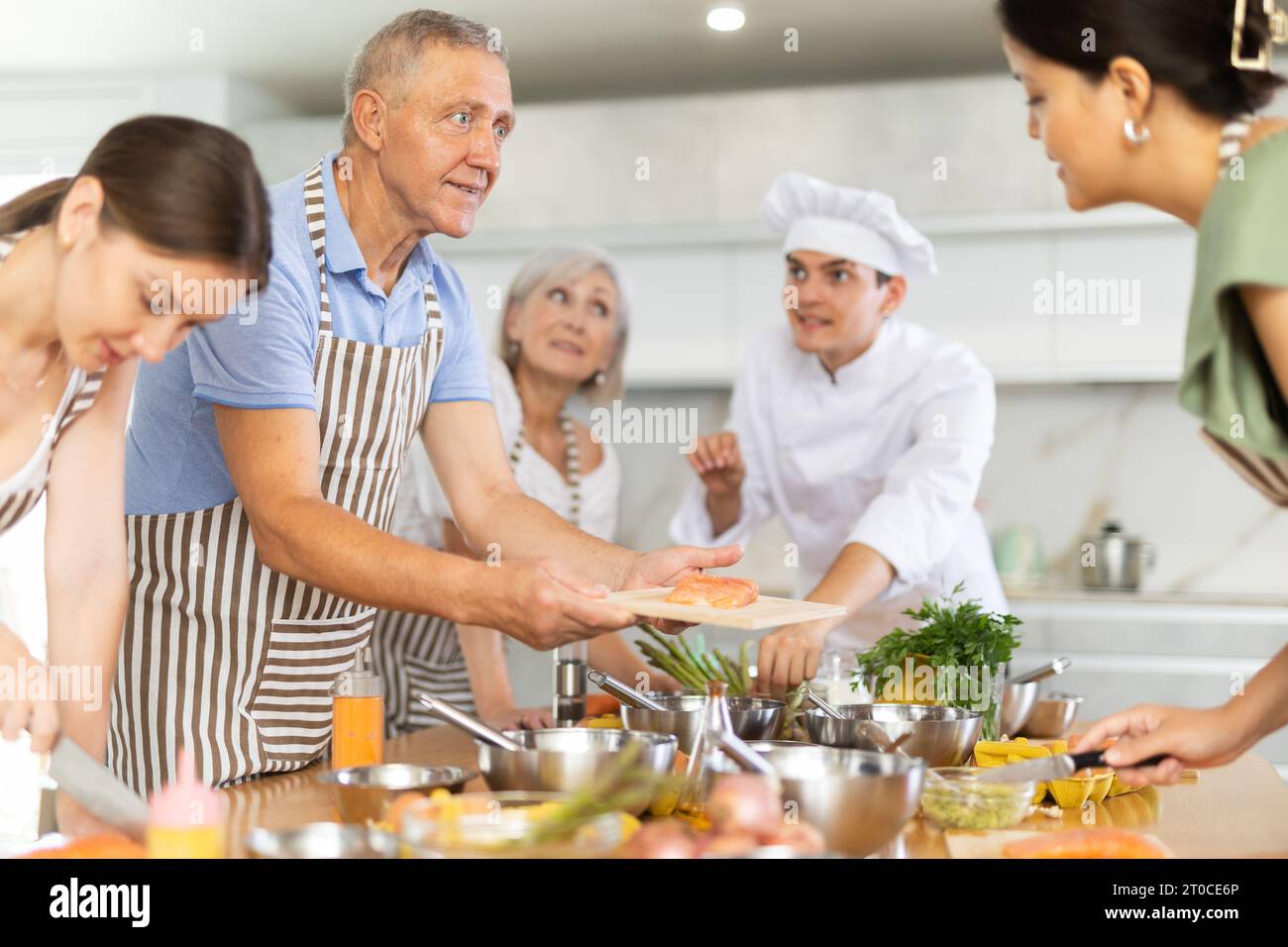 Elderly man teaches young hi-res stock photography and images - Alamy