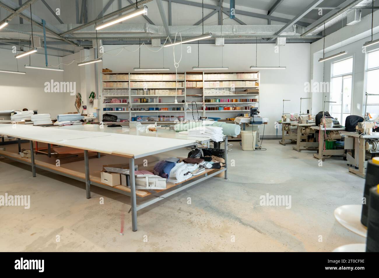Interior of a sewing warehouse of furniture factory with equipment and ...