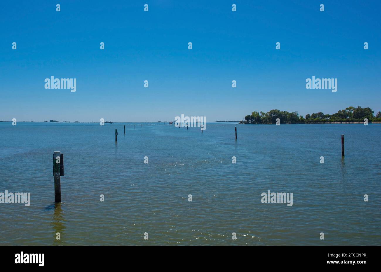 Markers show the edge of a navigable channel in the shallow waters in ...