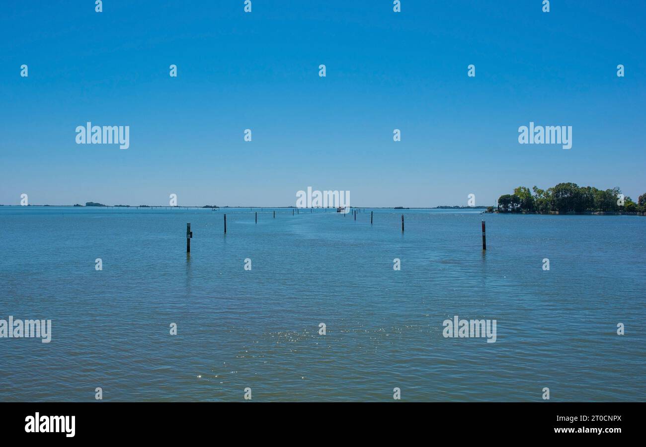 Markers show the edge of a navigable channel in the shallow waters in ...