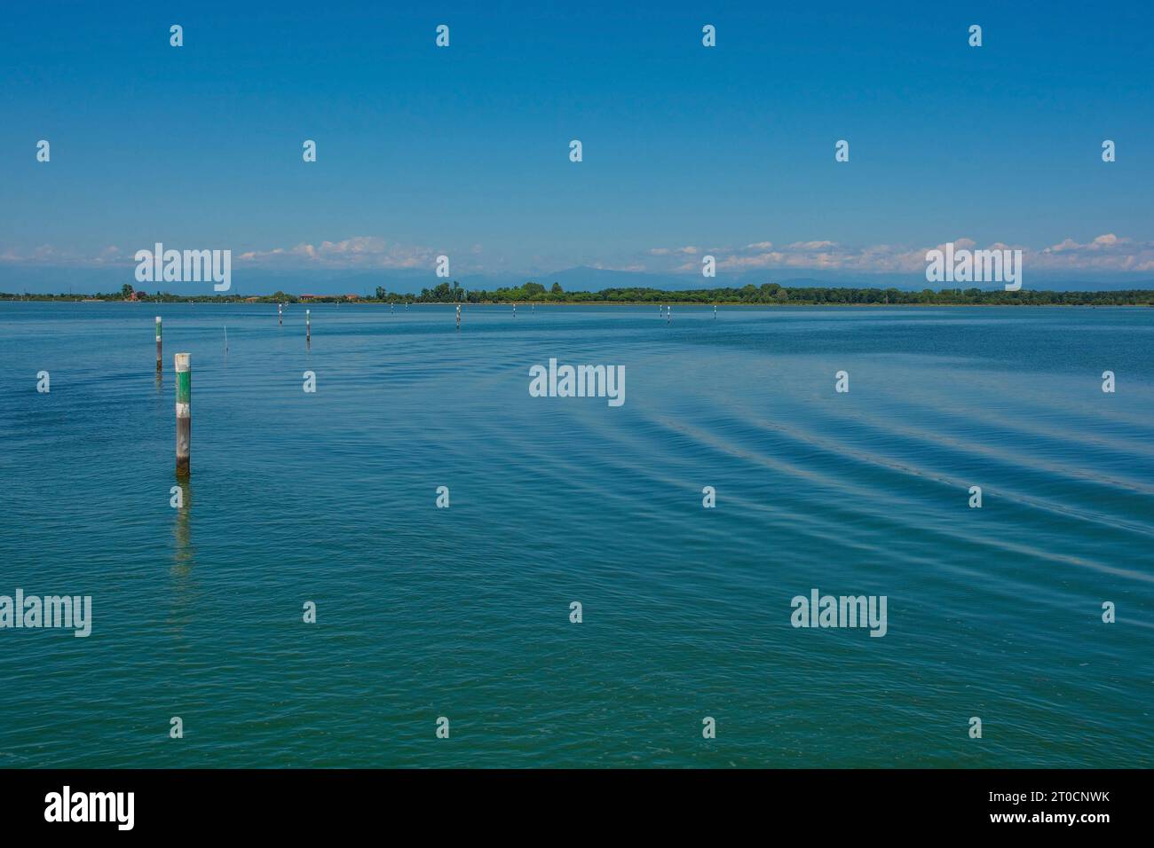 Markers show the edge of a navigable channel in the shallow waters in ...