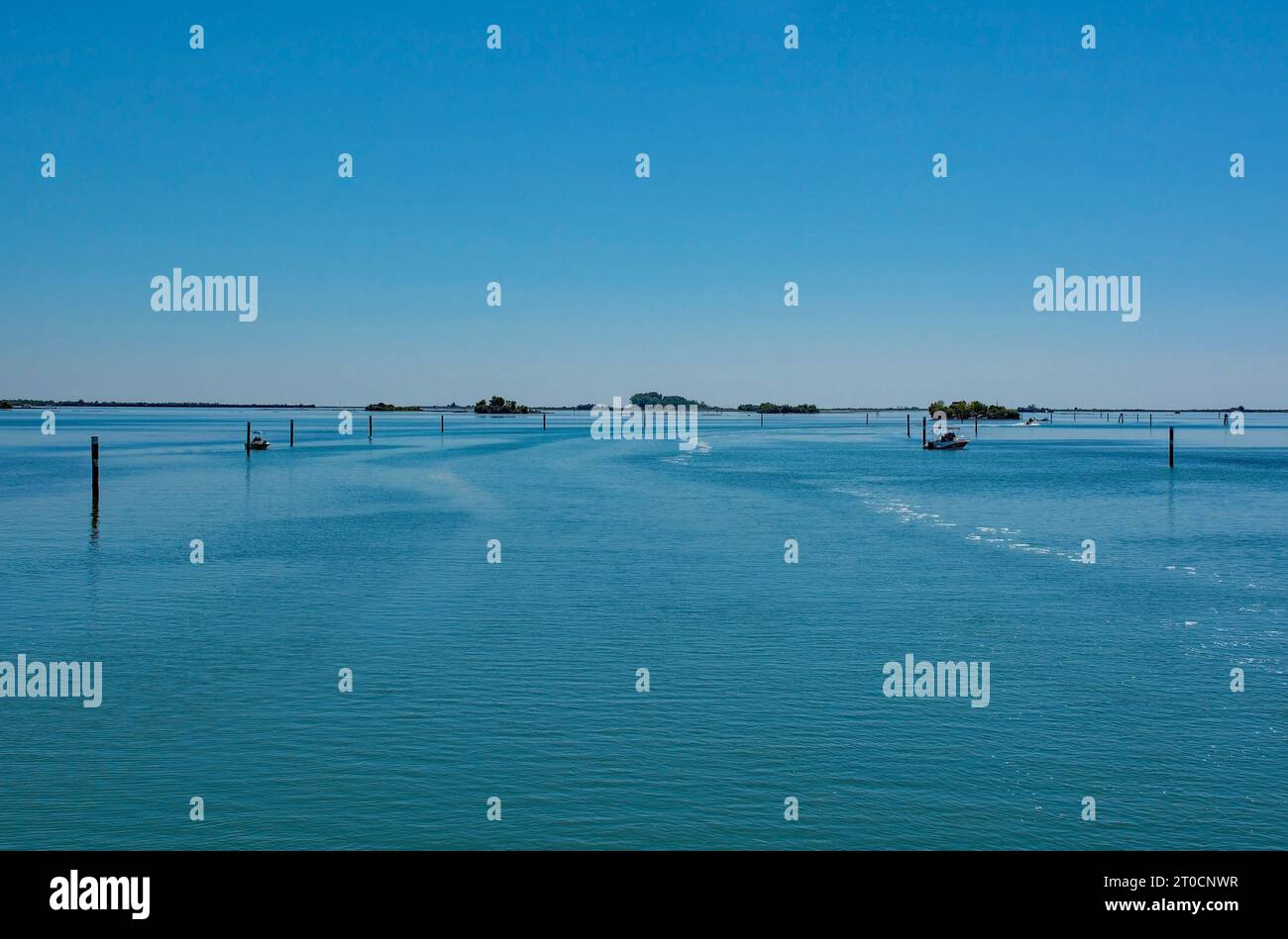 Markers show the edge of a navigable channel in the shallow waters in ...