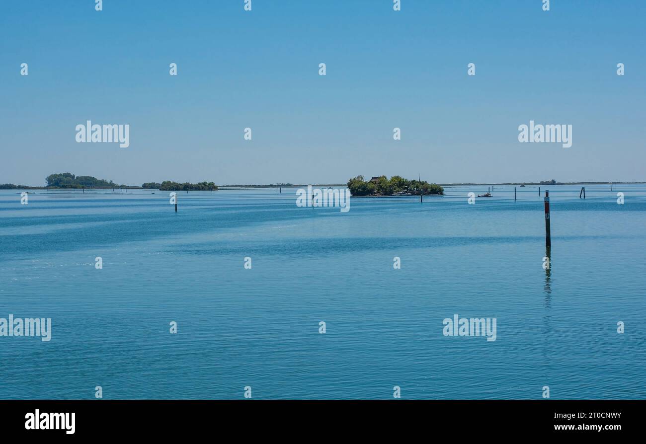 Markers show the edge of a navigable channel in the shallow waters in ...
