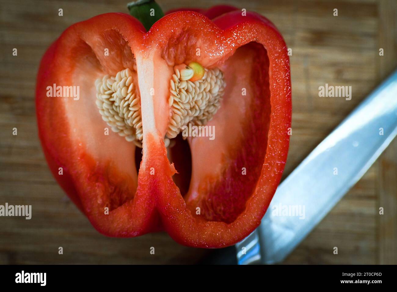 Red pepper cut in half Stock Photo - Alamy