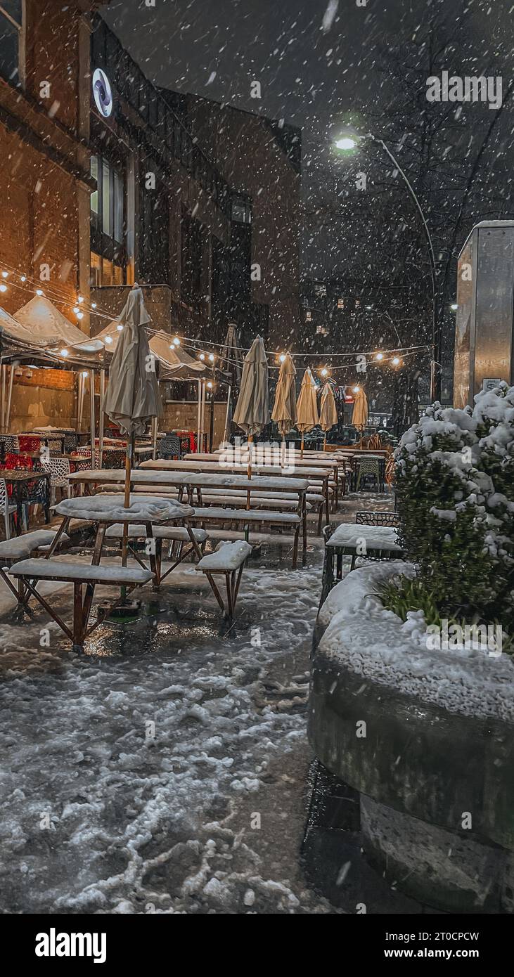 An outdoor seating area featuring a table, chairs, and umbrellas in a ...