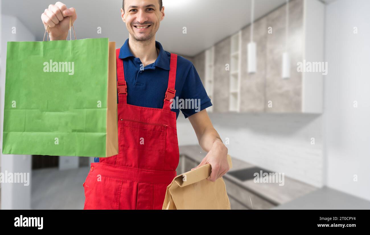 box with fast food being carried by delivery man in uniform for one of ...