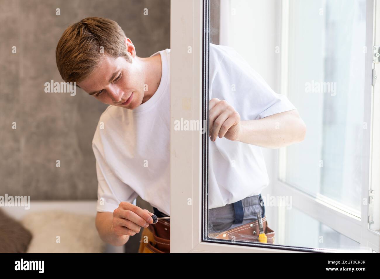 Construction worker installing window in house Stock Photo - Alamy